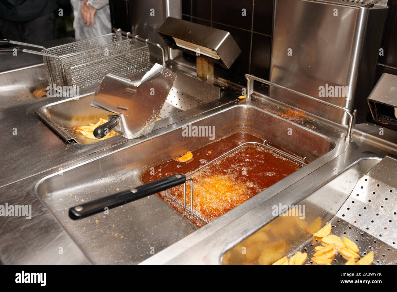 Deep fryer with boiling oil in commercial kitchen, fast food restaurant ...
