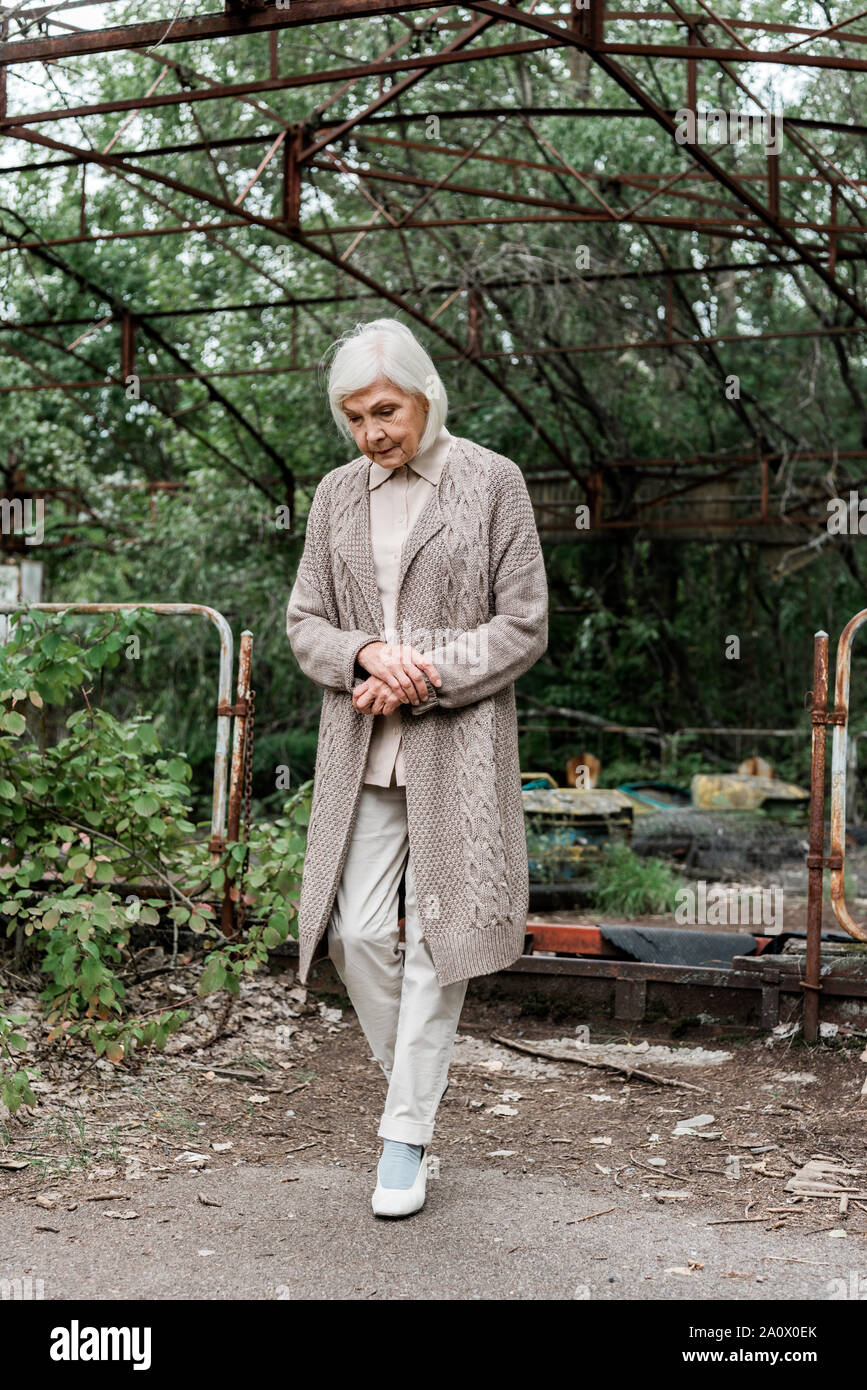 upset senior woman walking in amusement park Stock Photo - Alamy