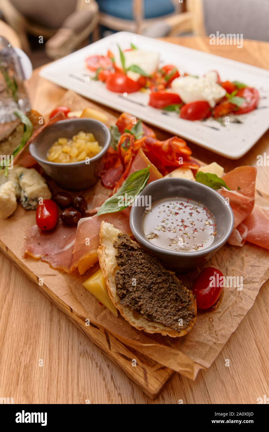 Meat, cheese and another starters on wooden board, Italian food Stock ...