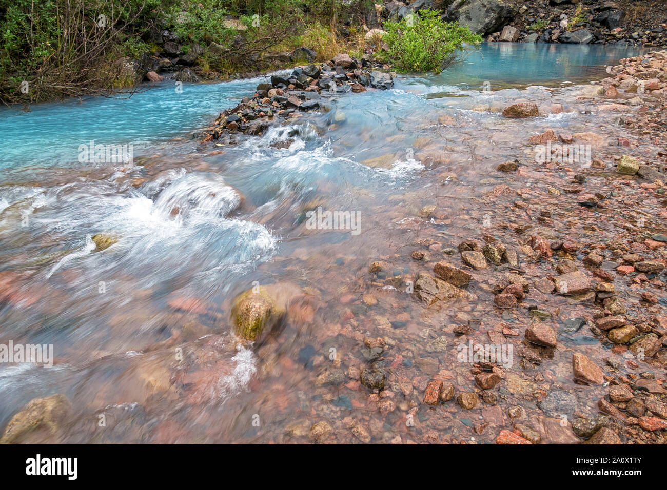 Blue spring in the mountains, source of crystal pure natural water ...