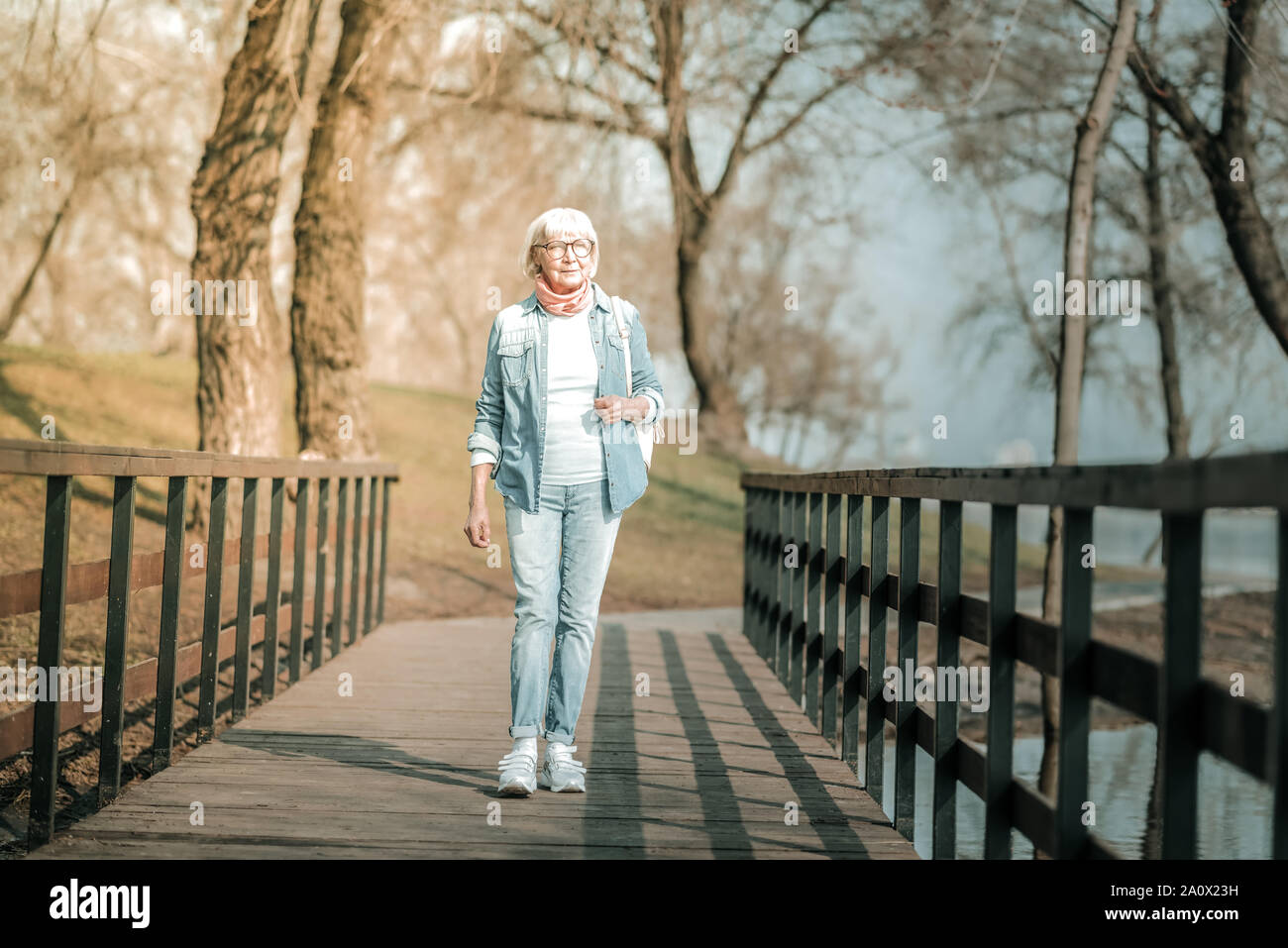 Happy bewitching lady in advanced years taking a stroll Stock Photo - Alamy