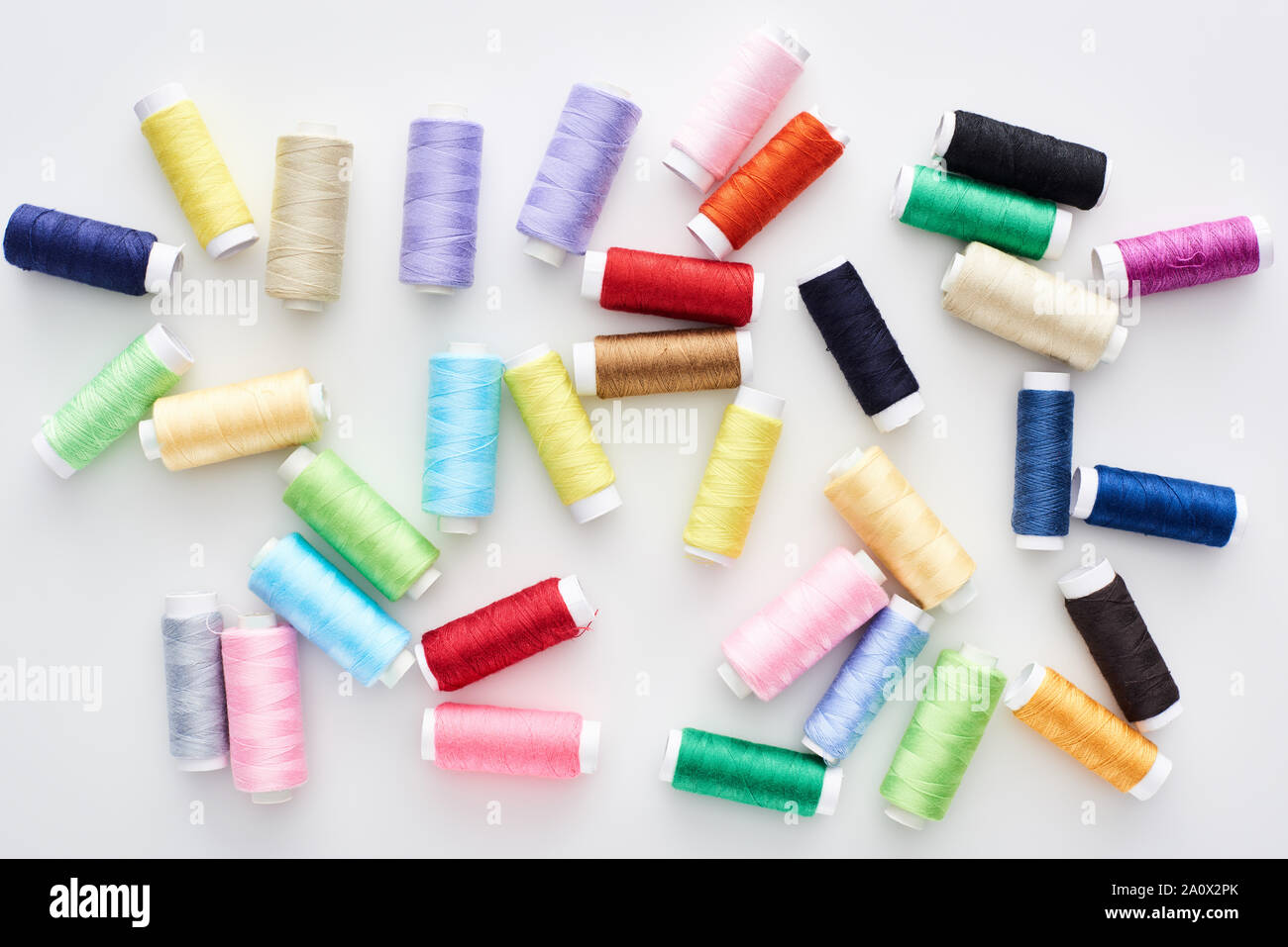 top view of bright and colorful threads on white background Stock Photo ...