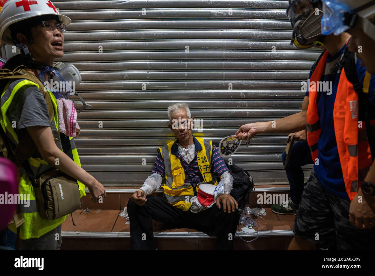 Medical volunteers help an elderly man who were pepper sprayed by the ...
