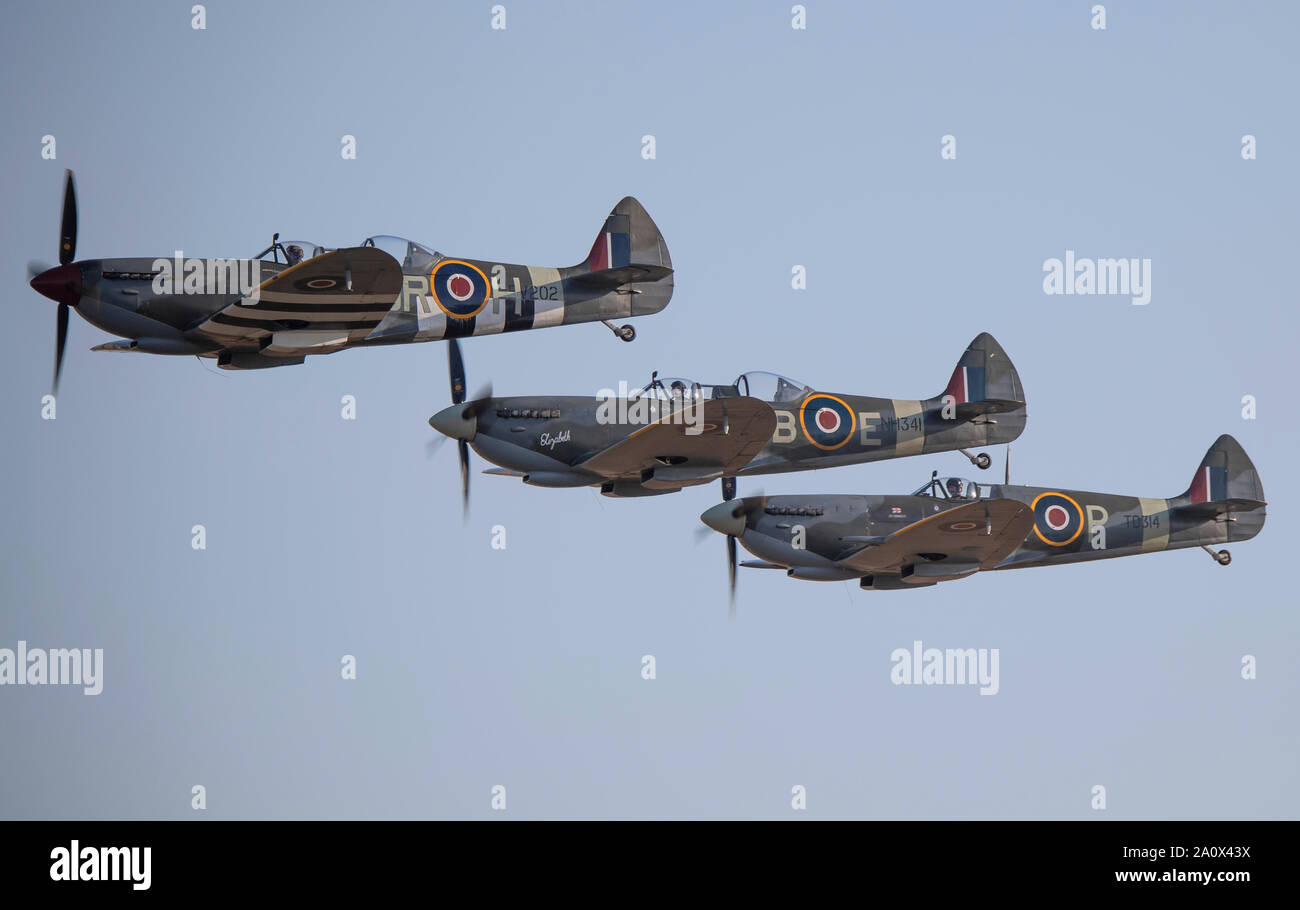 Group of three WW2 Supermarine Spitfire warplane in formation flight at ...