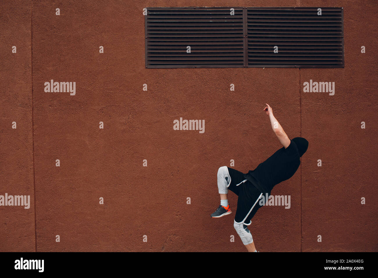 Parkour young man making acrobatic trick and flip jumping high Stock ...