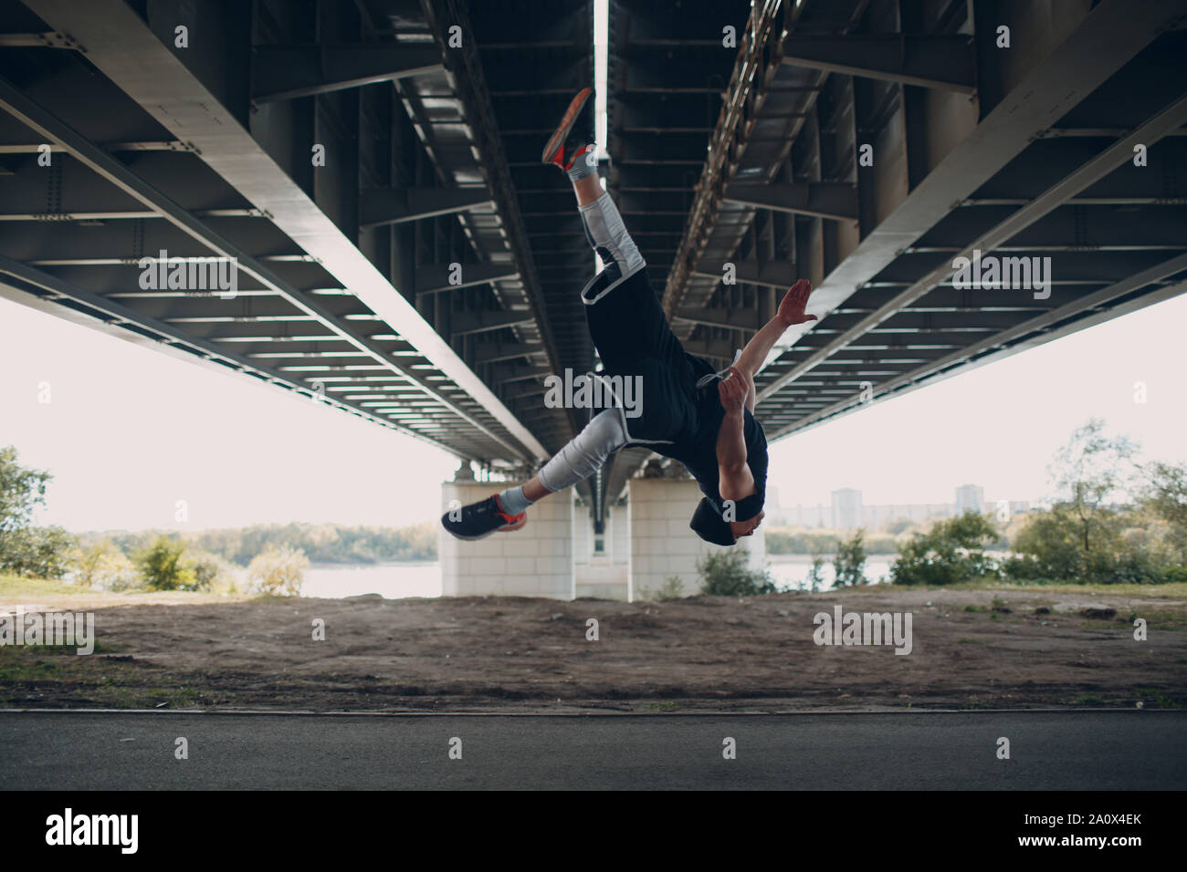 Parkour young man making acrobatic trick and flip jumping high Stock ...