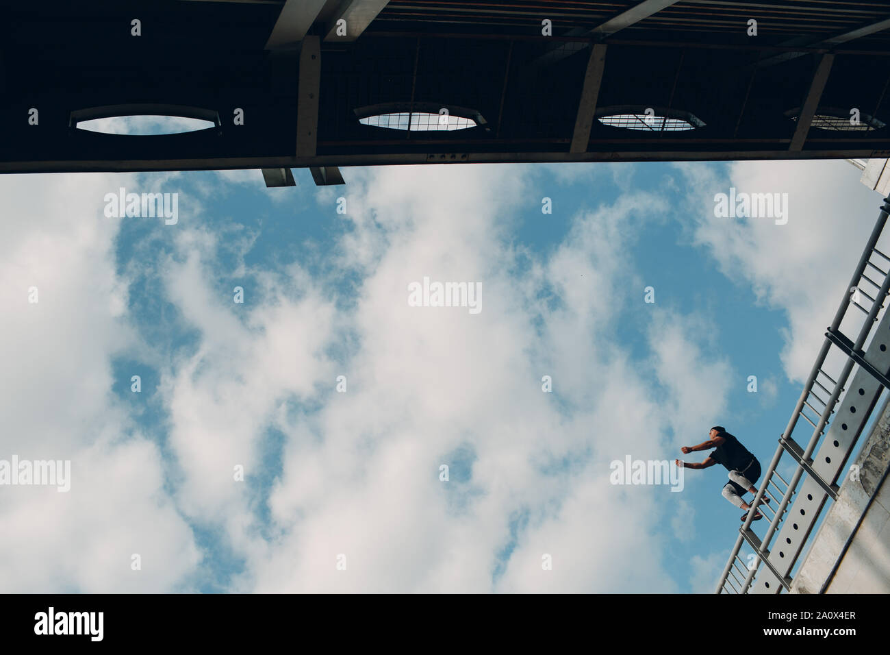 Parkour young man making acrobatic trick and flip jumping high Stock ...