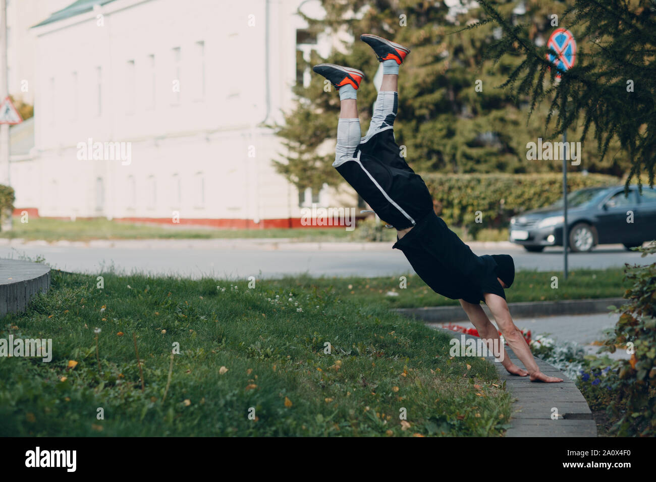 Parkour young man making acrobatic trick and flip jumping high Stock ...