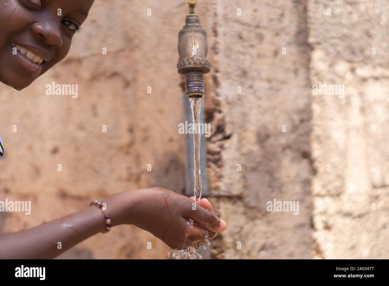 Close-Up Shot of a Tap with a black ethnicity African Girl Drinks Stock ...