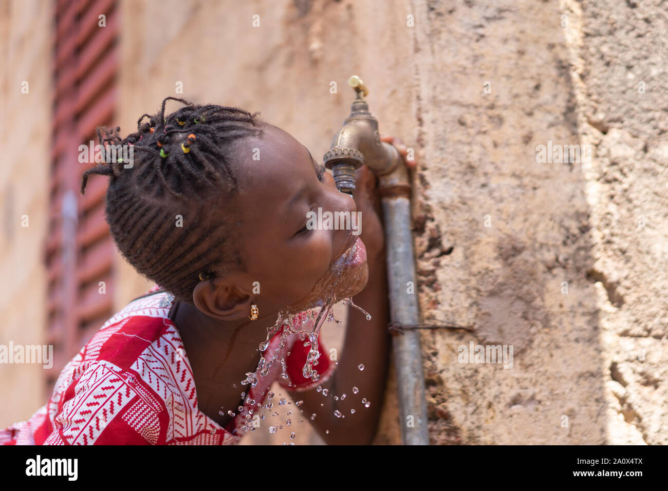 Girl drinking water from tap hi-res stock photography and images - Alamy