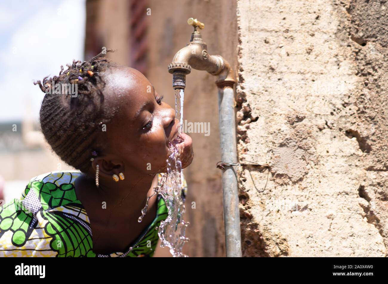 Boy drinking from tap africa hi-res stock photography and images - Alamy