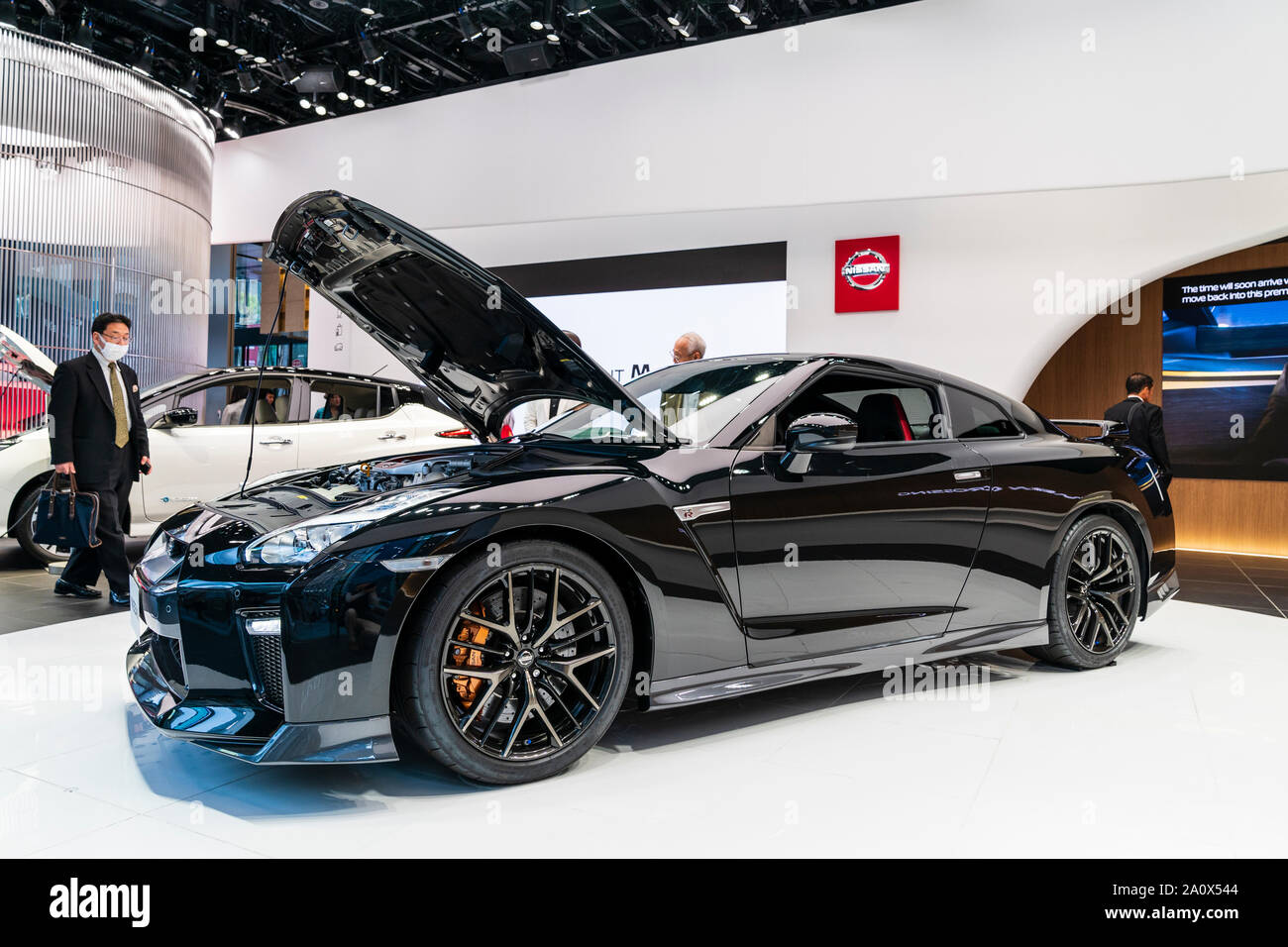 Nissan flagship showroom, Ginza, Tokyo. People viewing the display of a ...