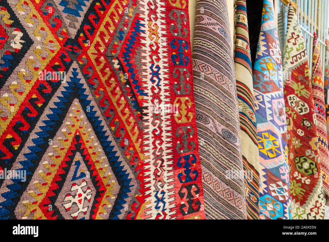 Different traditional turkish carpets hanging on a wall on a street in ...