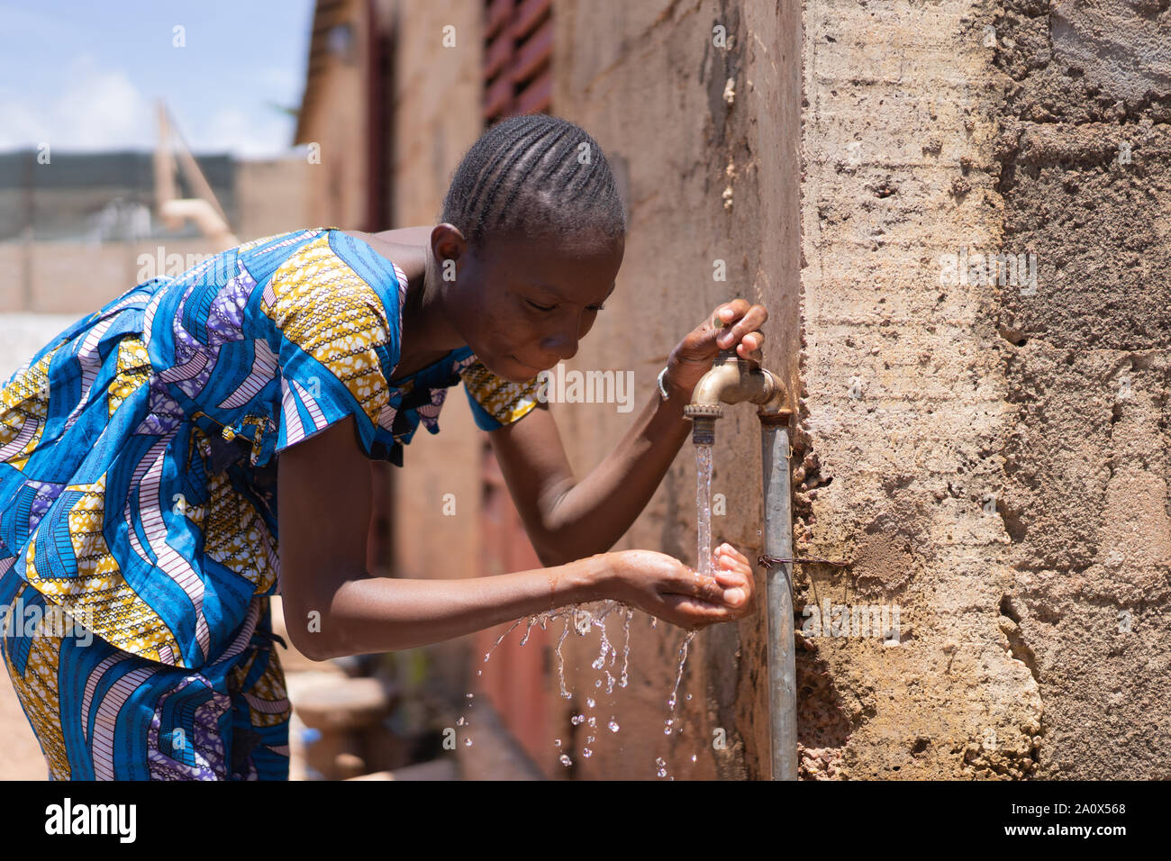 Woman getting water well hi-res stock photography and images - Alamy