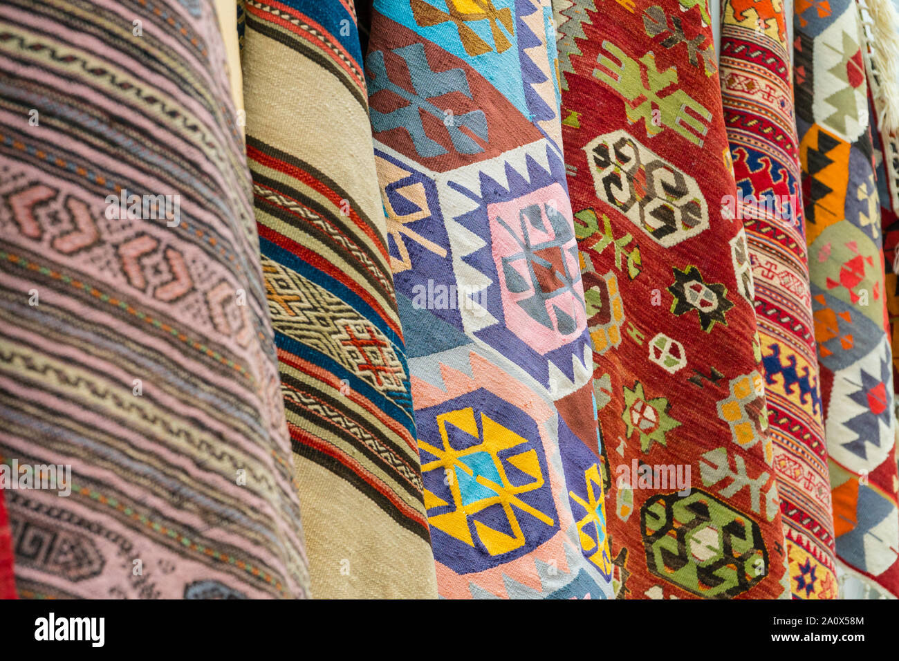 Different traditional turkish carpets hanging on a wall on a street in ...