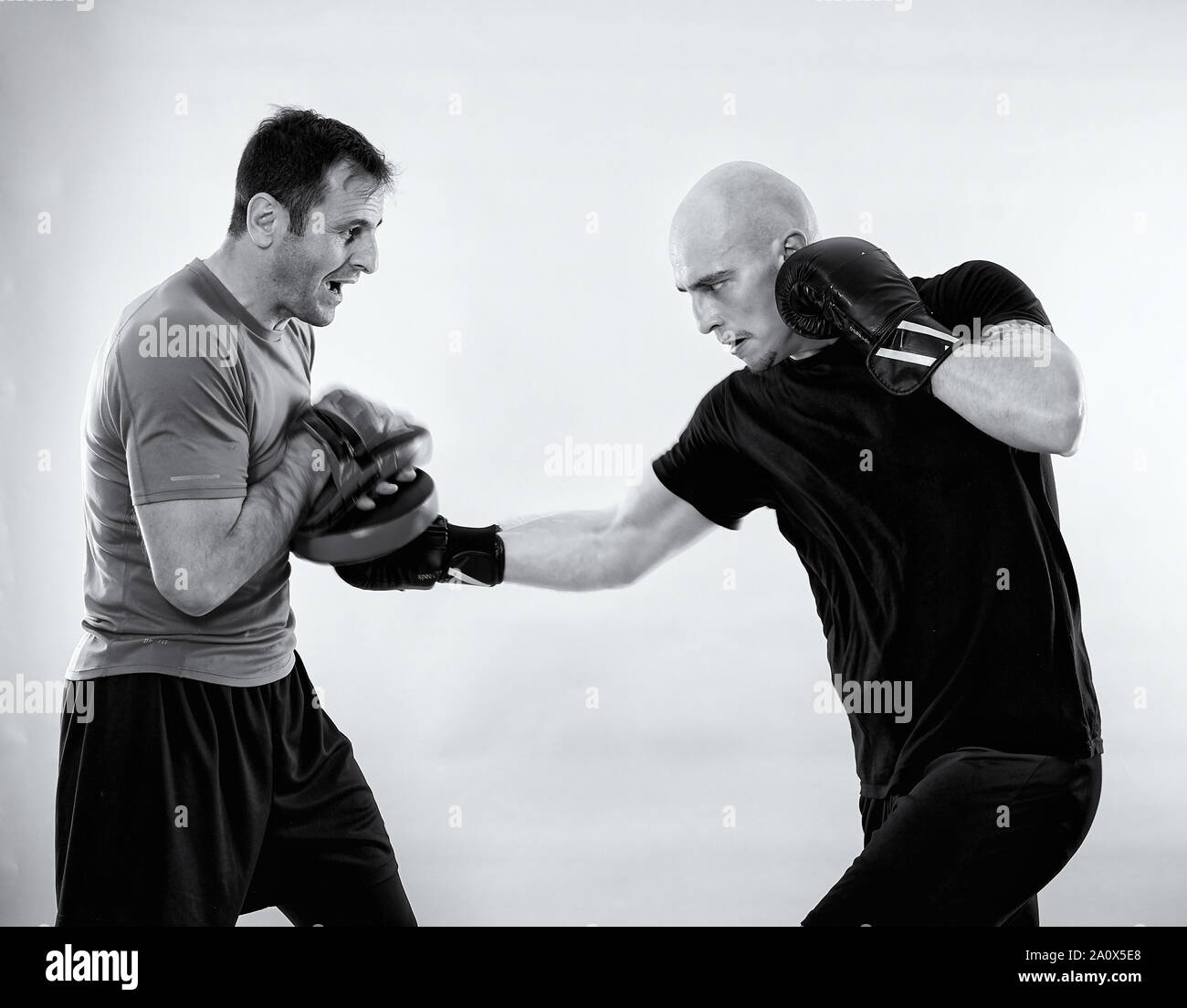 Boxer and his coach hitting mitts, black and white image Stock Photo ...
