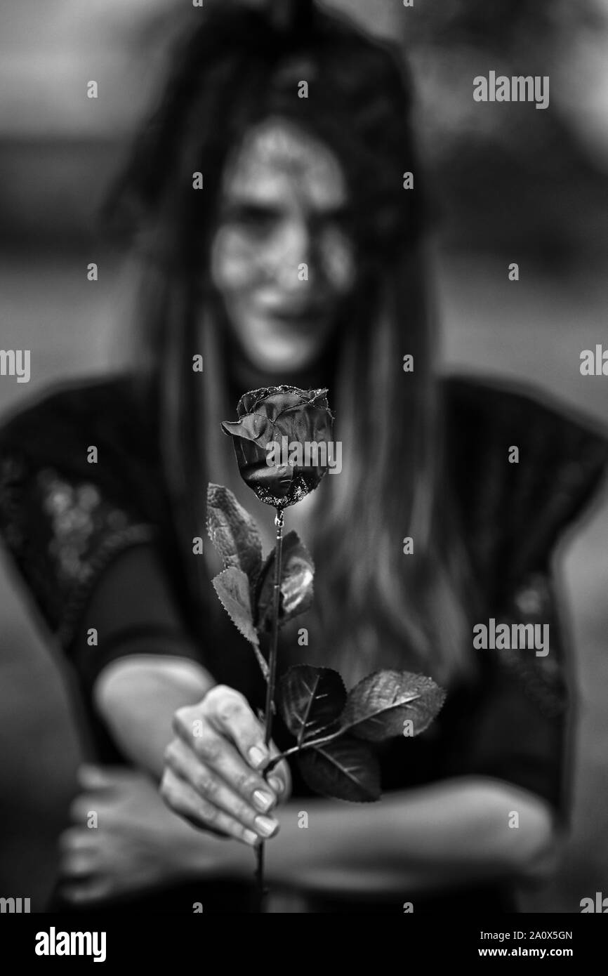 Black and white portrait of a widow with a dar rose, Halloween theme ...