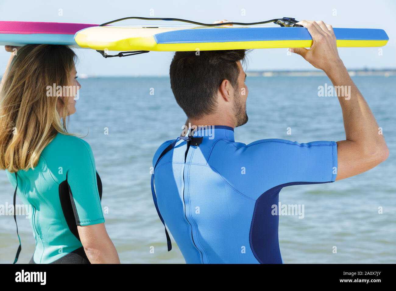 surfer beginner and instructor on a beach Stock Photo - Alamy