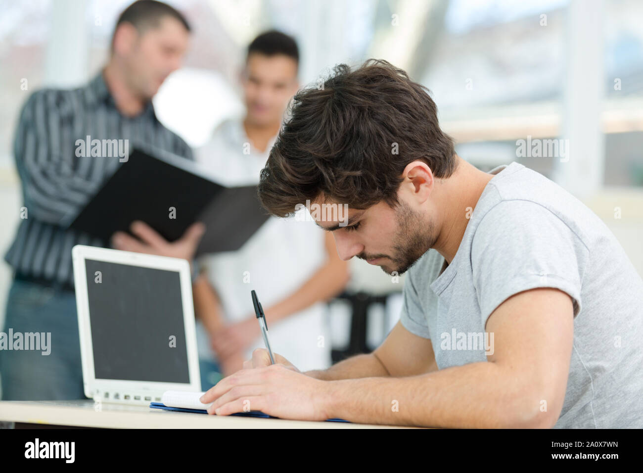 young man taking notes student Stock Photo - Alamy