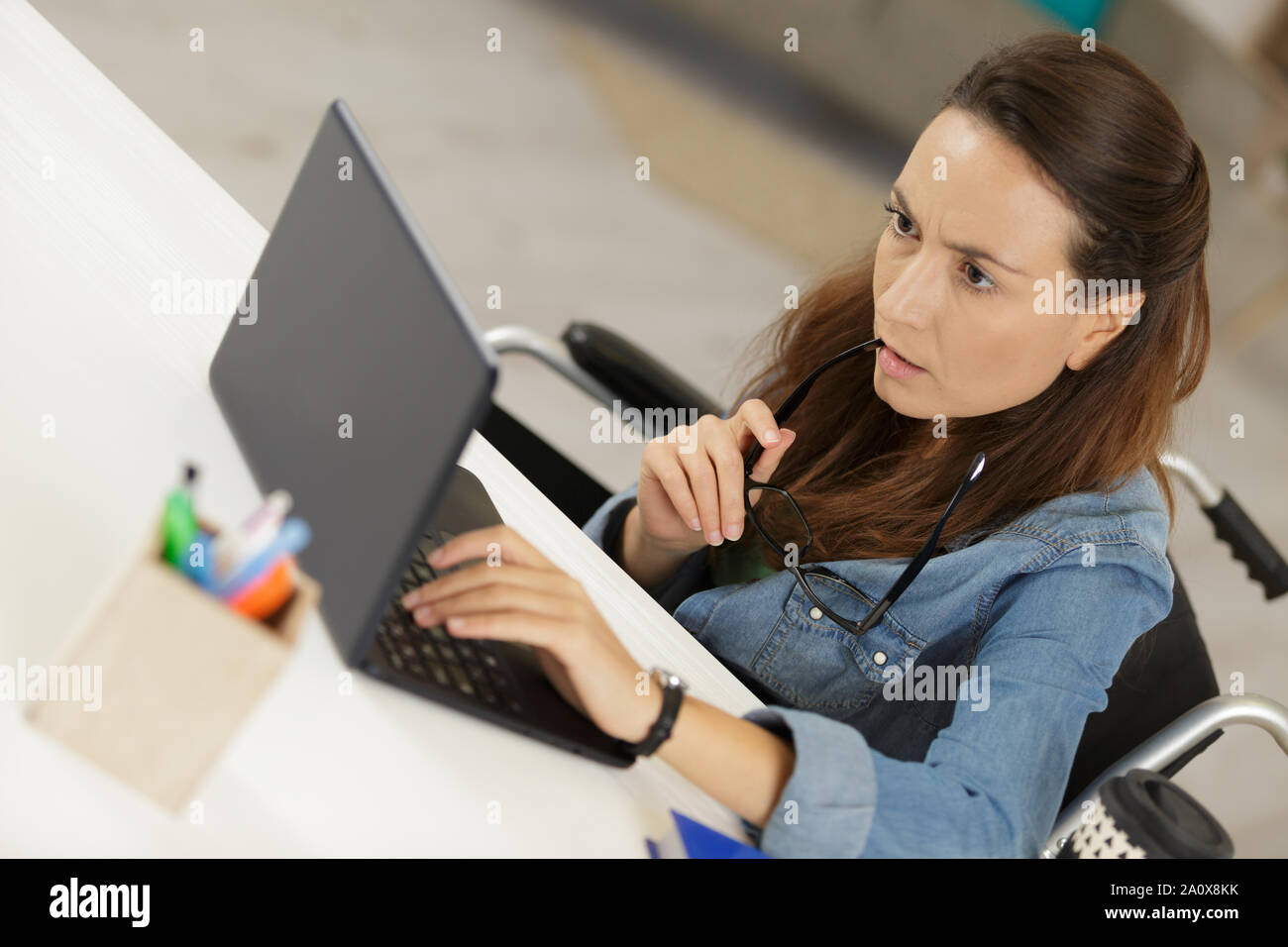 creative designer sitting in wheelchair in front of computer Stock ...