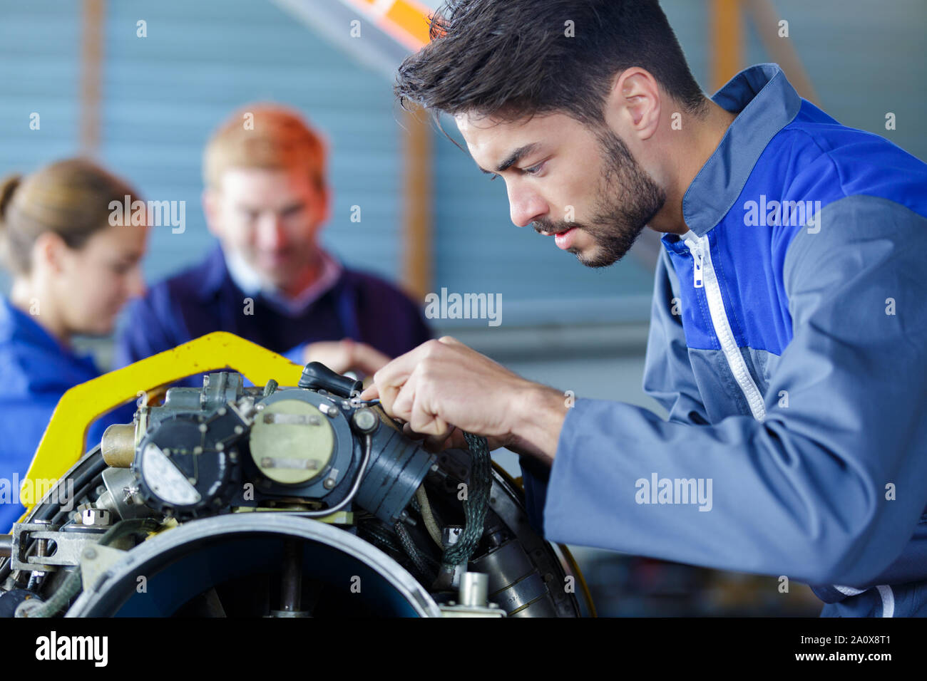 young engineer working on aircraft motor Stock Photo - Alamy