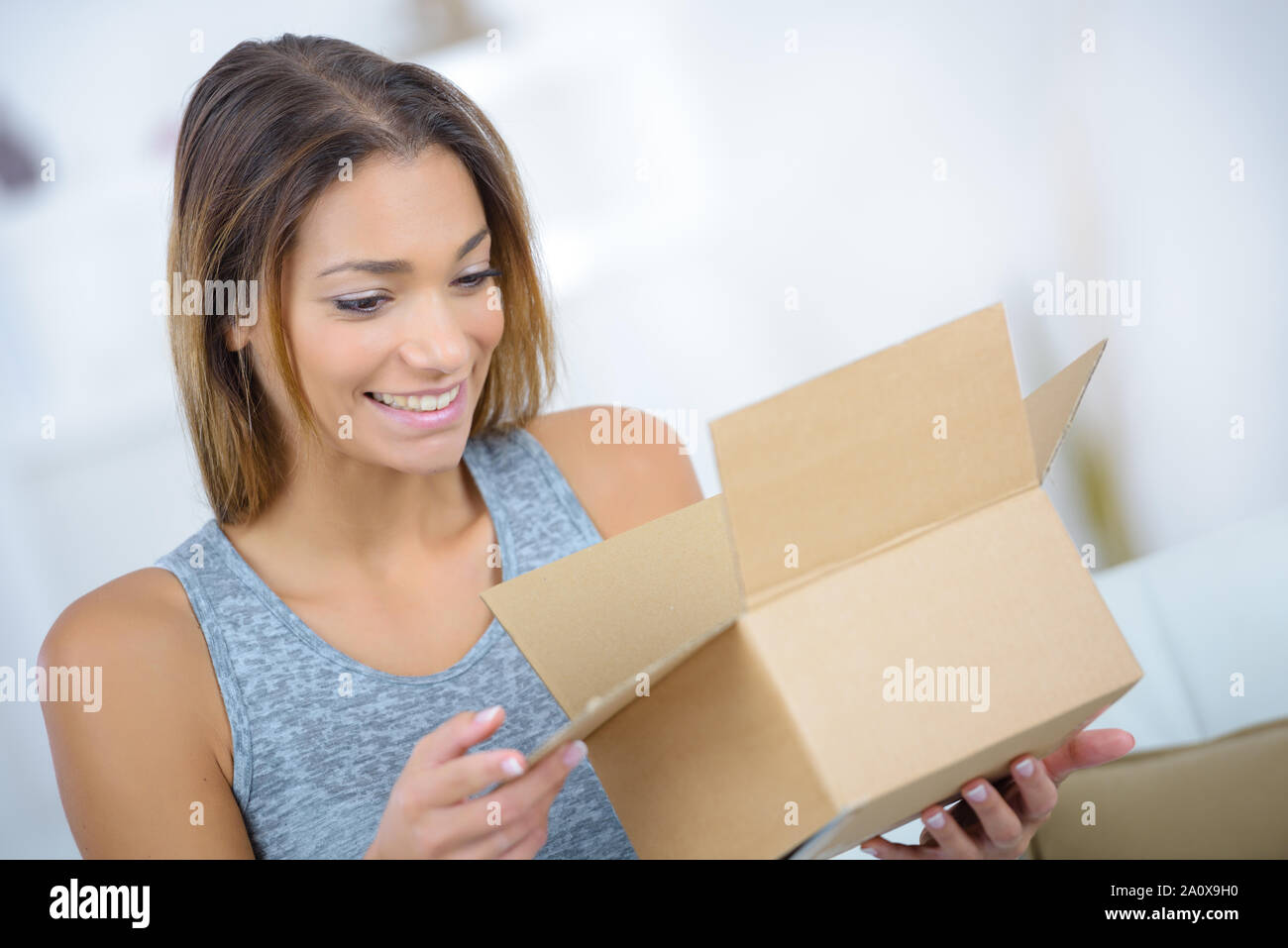 Beautiful young woman opening box hi-res stock photography and images ...