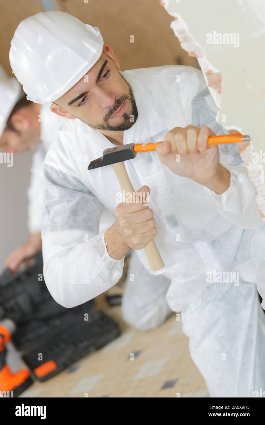 the photo depicts a man with a chisel and hammer Stock Photo - Alamy