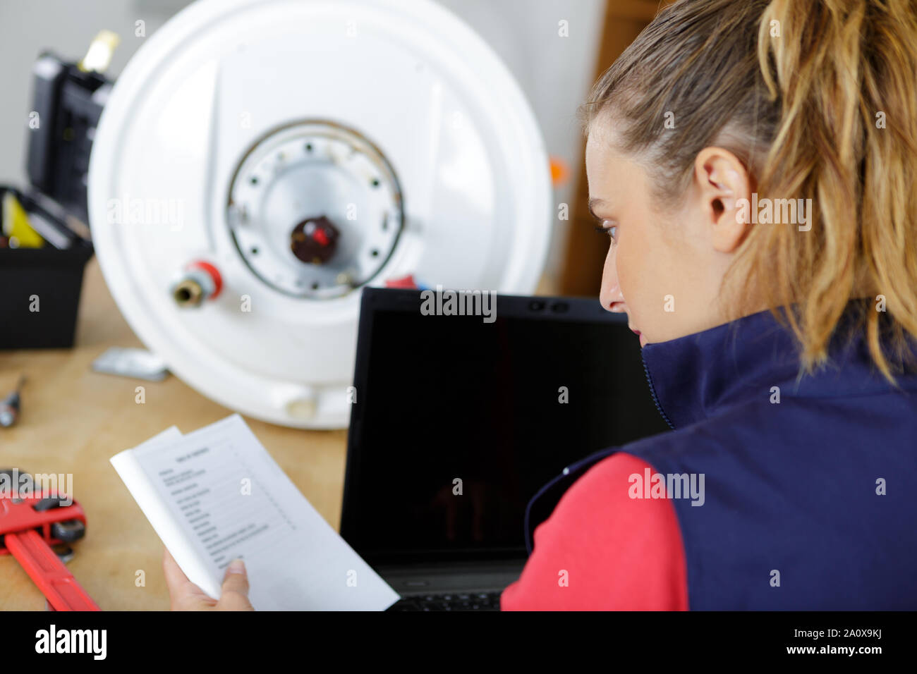 female technician reading instruction manual Stock Photo - Alamy