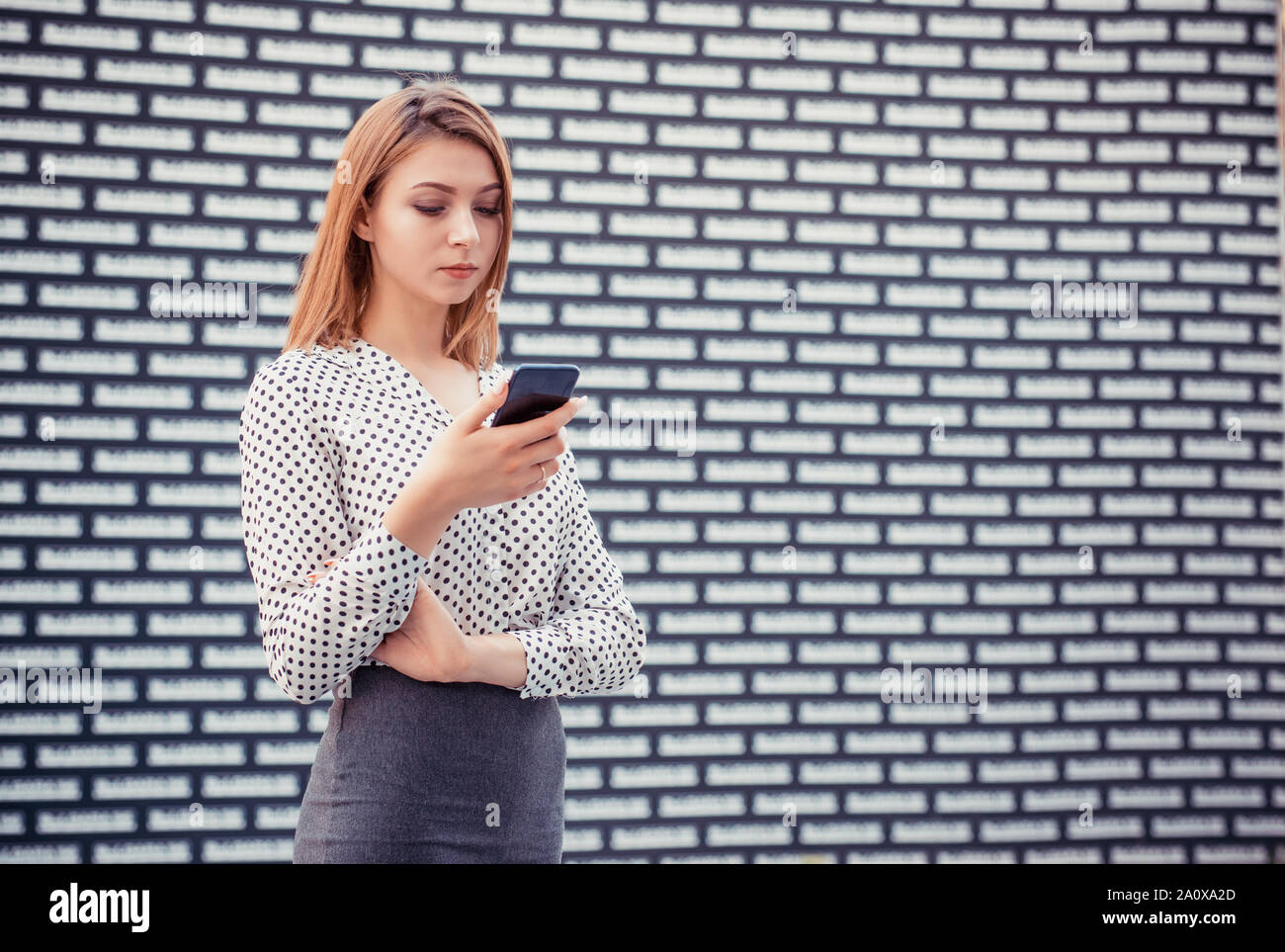 Portrait of beautiful Serious young woman surfing the Internet on cell ...