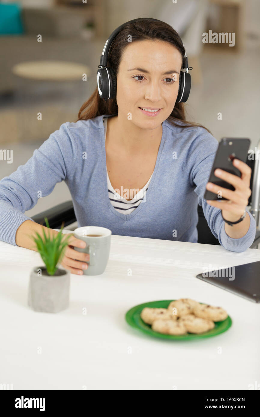 Woman in the middle using cell phone text message hi-res stock ...