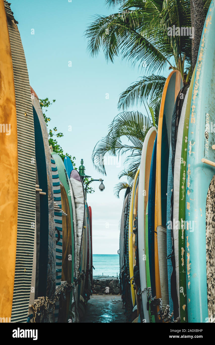Looking through a row of surfboards down to Waikiki Beach Stock Photo ...
