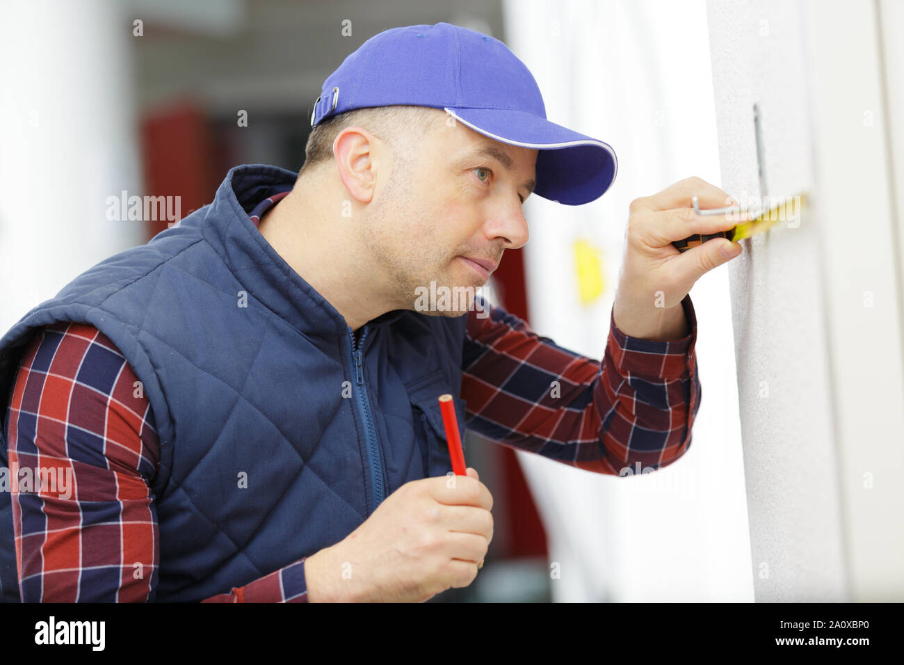 worker marking with pencil on wall Stock Photo - Alamy