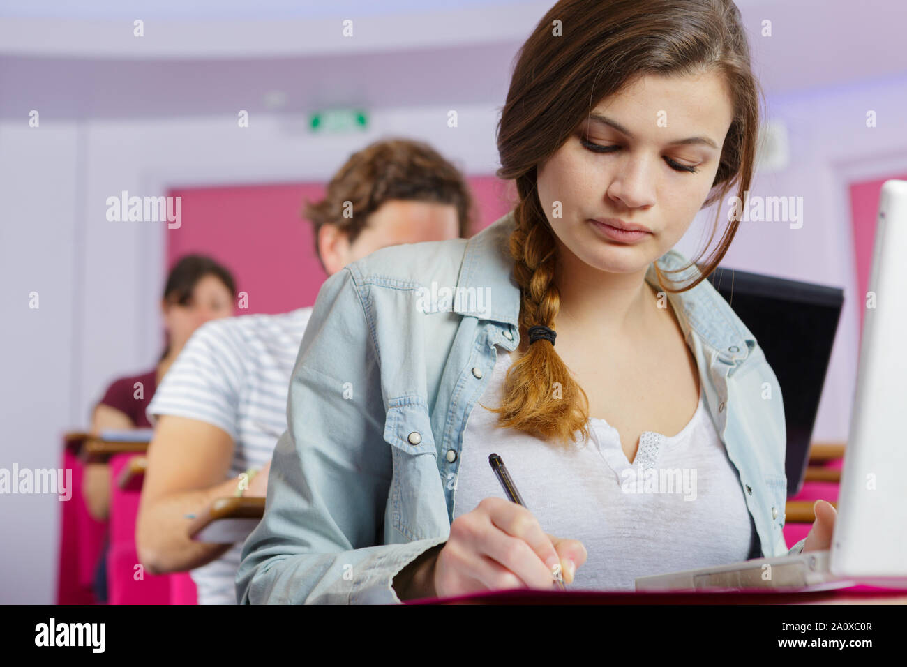 student girl writing test in classroom Stock Photo - Alamy