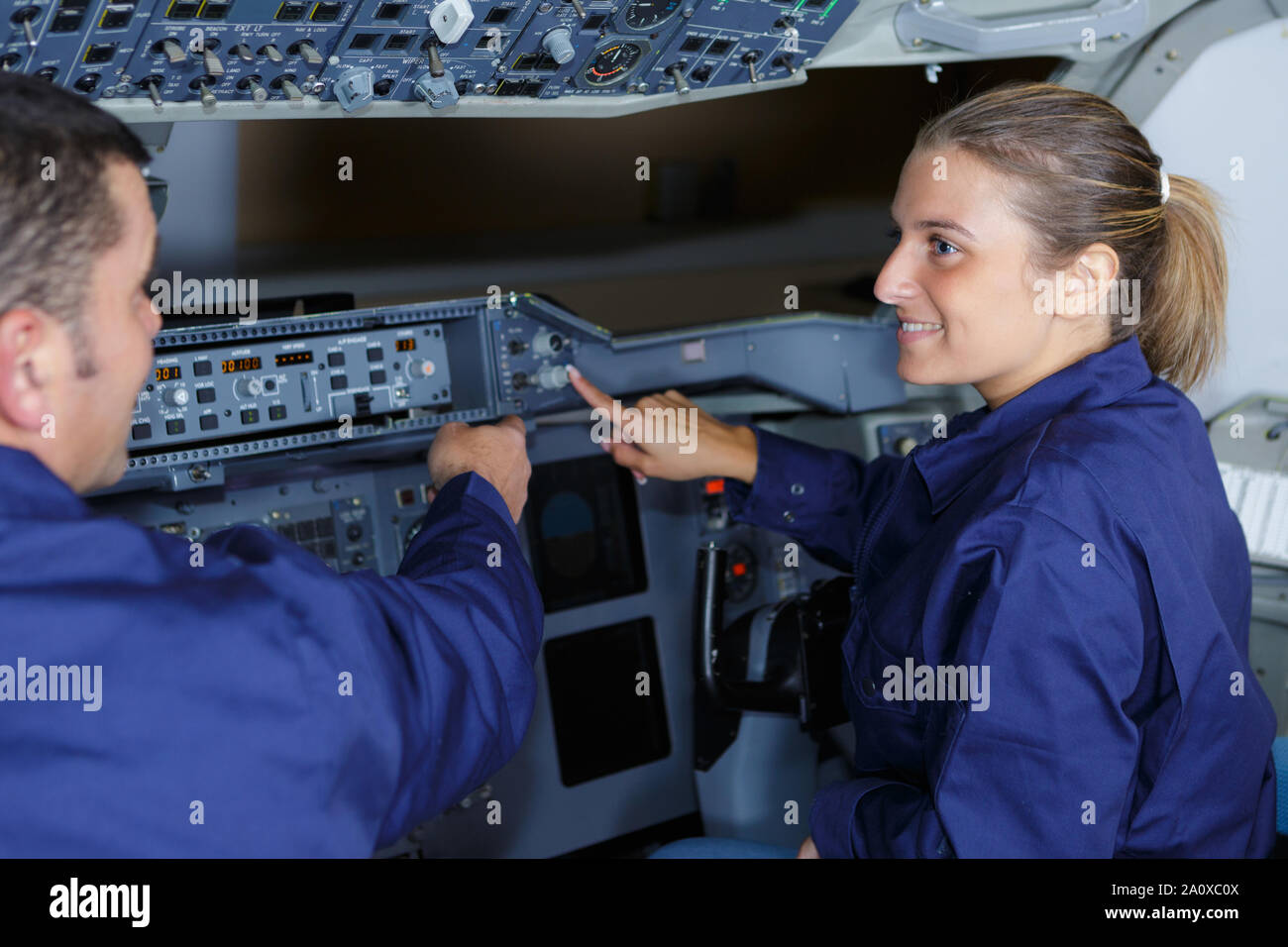 aviation apprentice pointing at panel Stock Photo - Alamy
