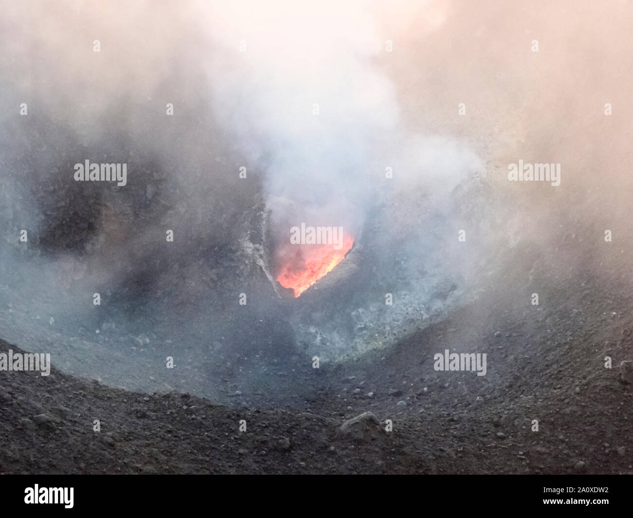 smoky crater scenery at Stromboli volcano near Sicily at evening time ...