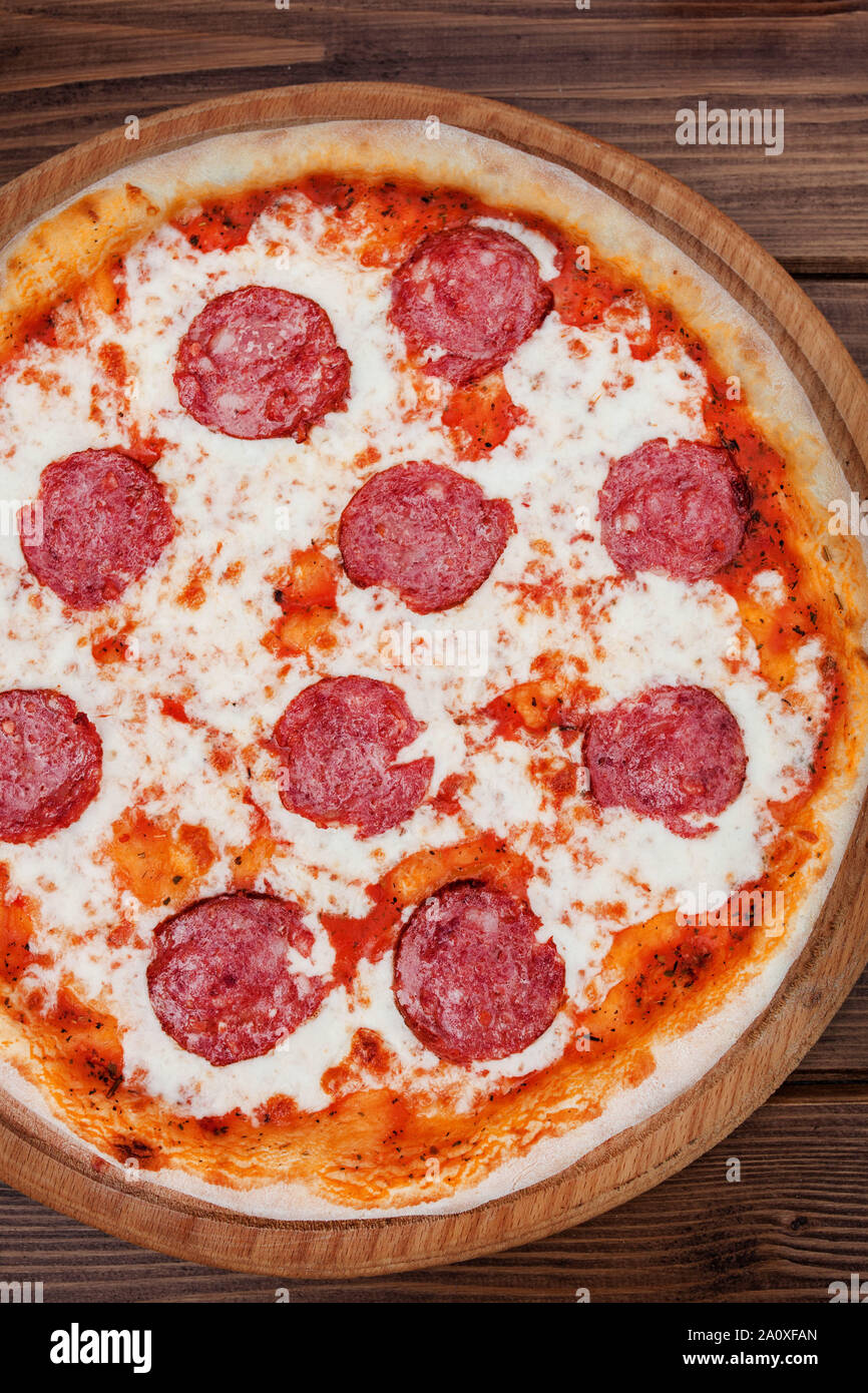 Italian Pepperoni pizza with salami on dark wooden background top view ...