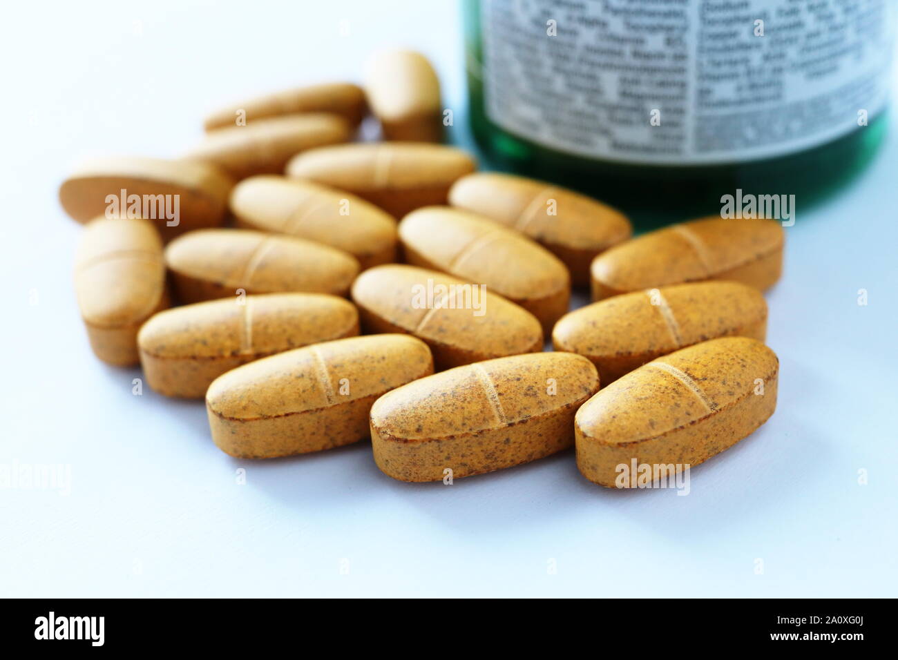 Multivitamin tablets and green container bottle with label showing ...