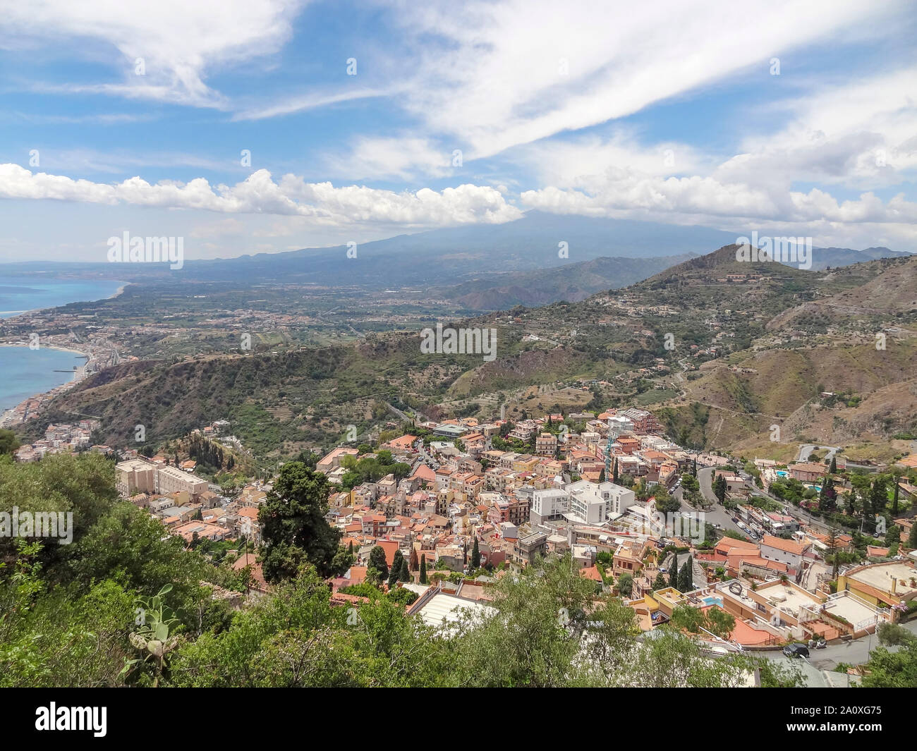 distant aerial view of Taormina, a comune in Sicily, Italy Stock Photo ...