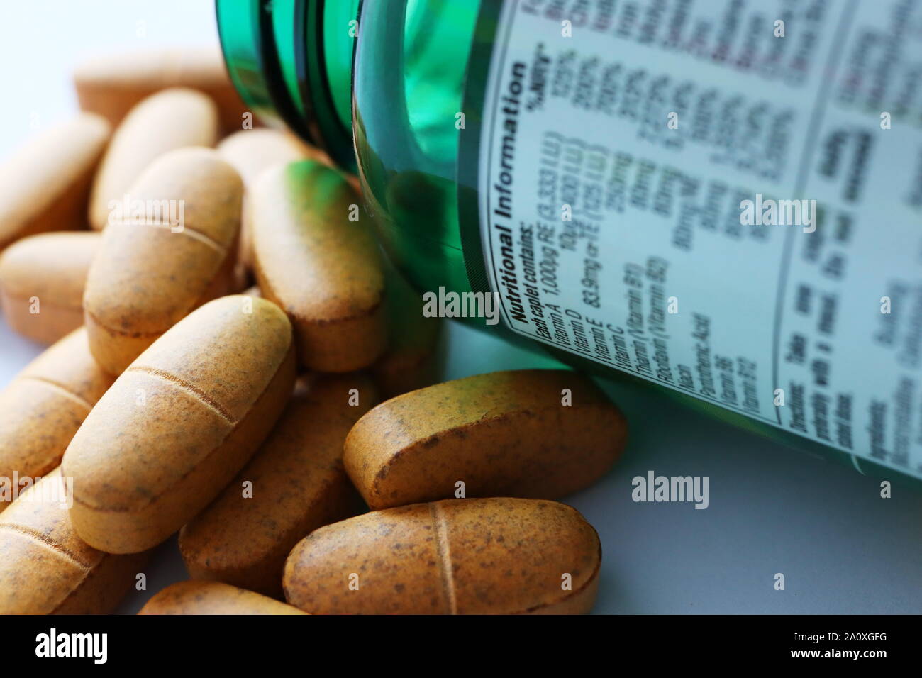 Multivitamin tablets and green container bottle with label showing ...