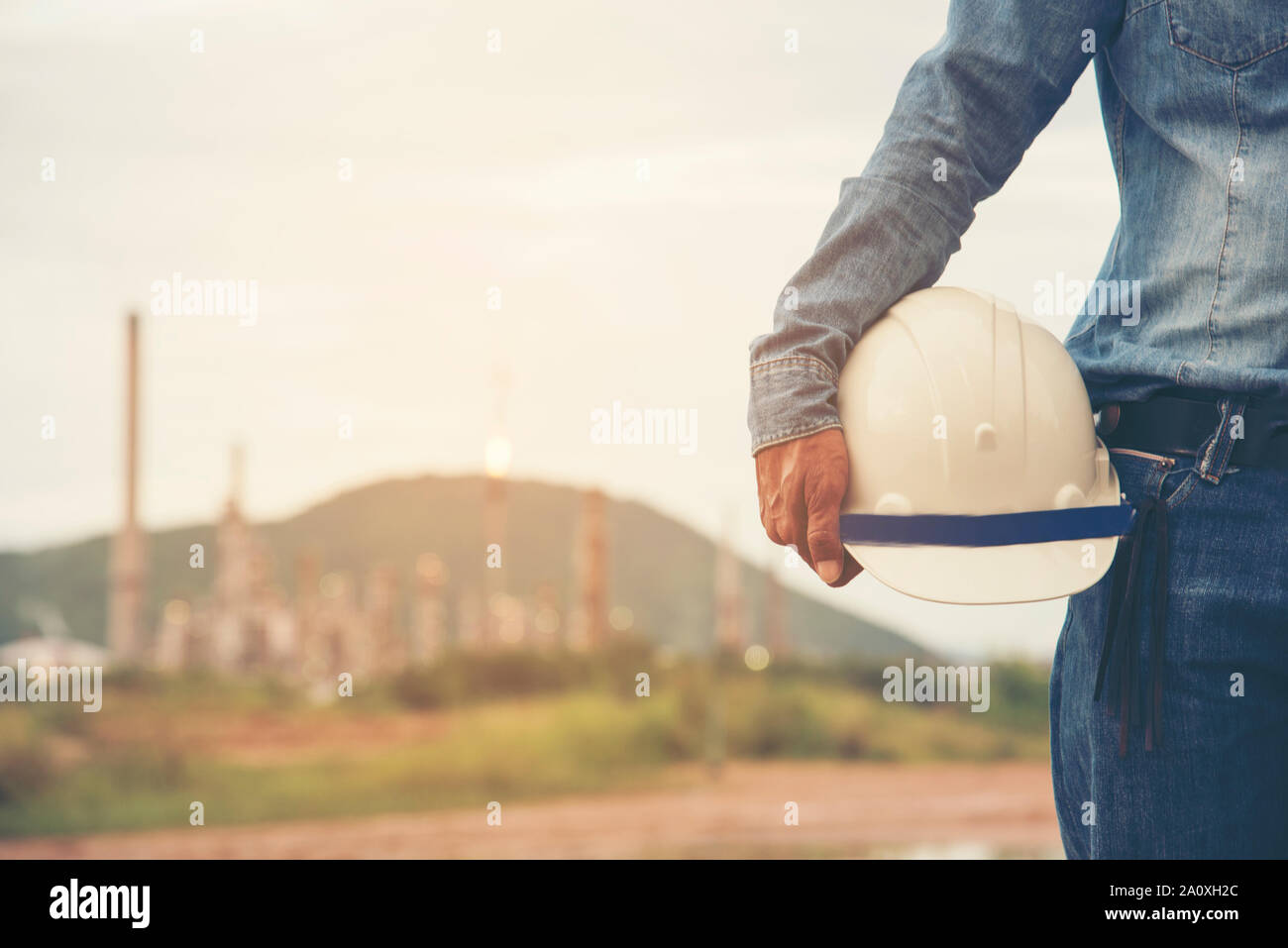 engineering working on construction site and holding yellow hard hat ...