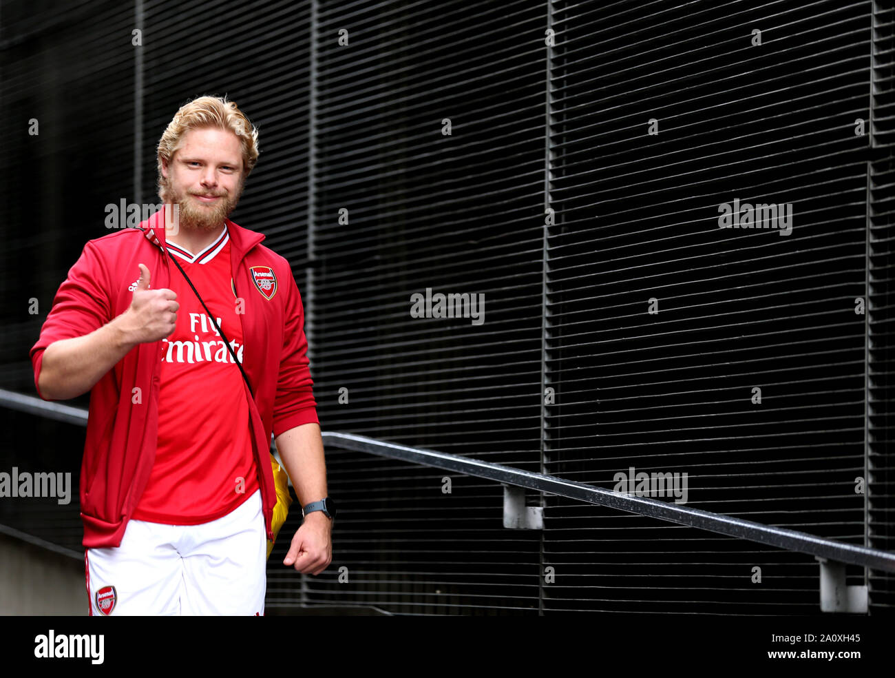 An Arsenal fan arrives at the stadium ahead of the Premier League match ...
