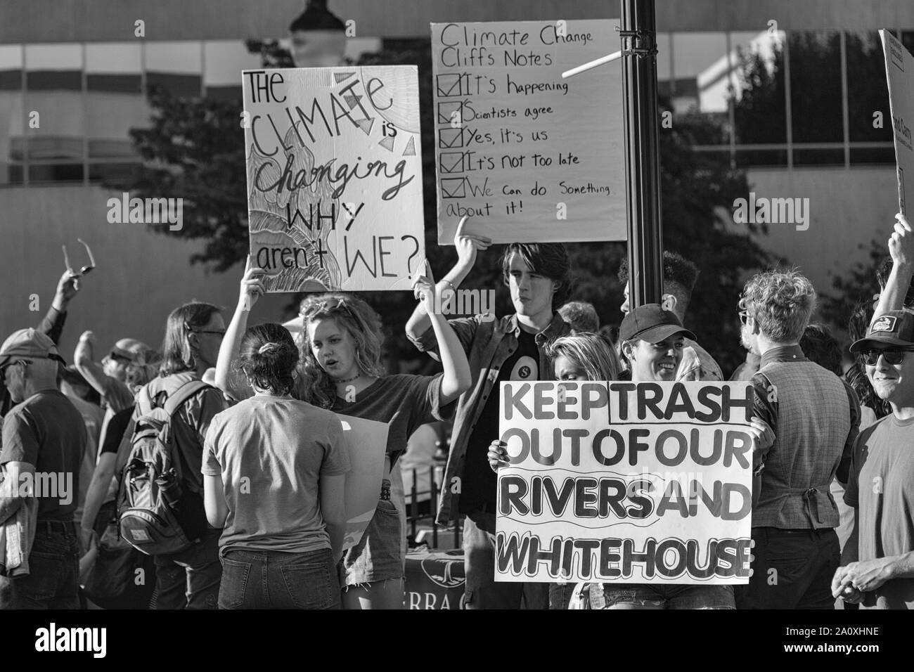 Protesters hold up signs to passing cars at the International Climate ...
