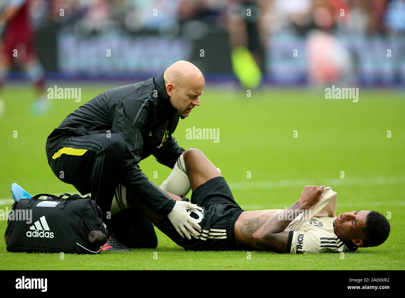 Manchester United's Marcus Rashford is treated for an injury during the ...