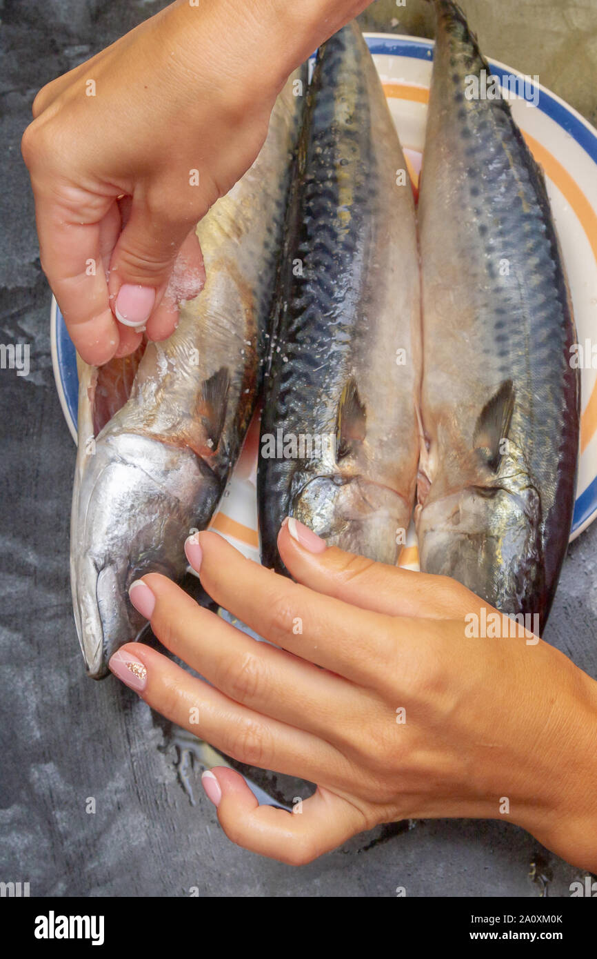 Marinating raw fish mackerel for baking on the grill Stock Photo - Alamy