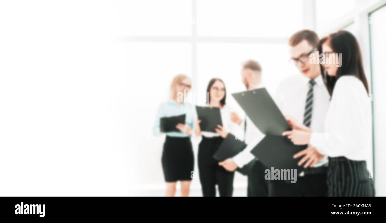 group of business people discussing documents for a new business ...