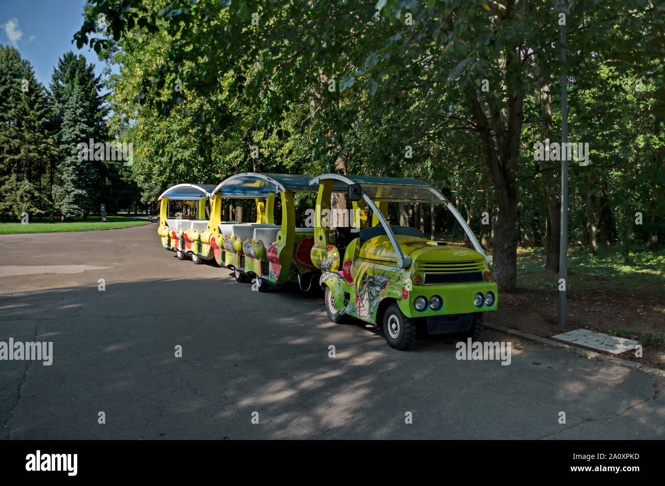 Summer view of the main trail with colorful carts for a trip in a ...