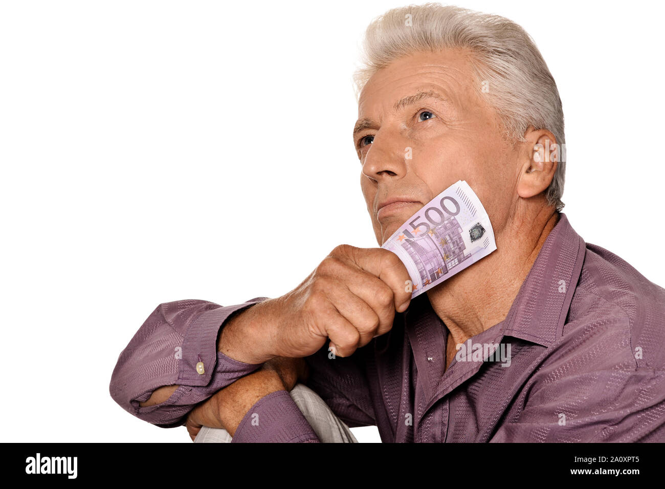 Portrait of elderly man holding euros isolated on white background ...