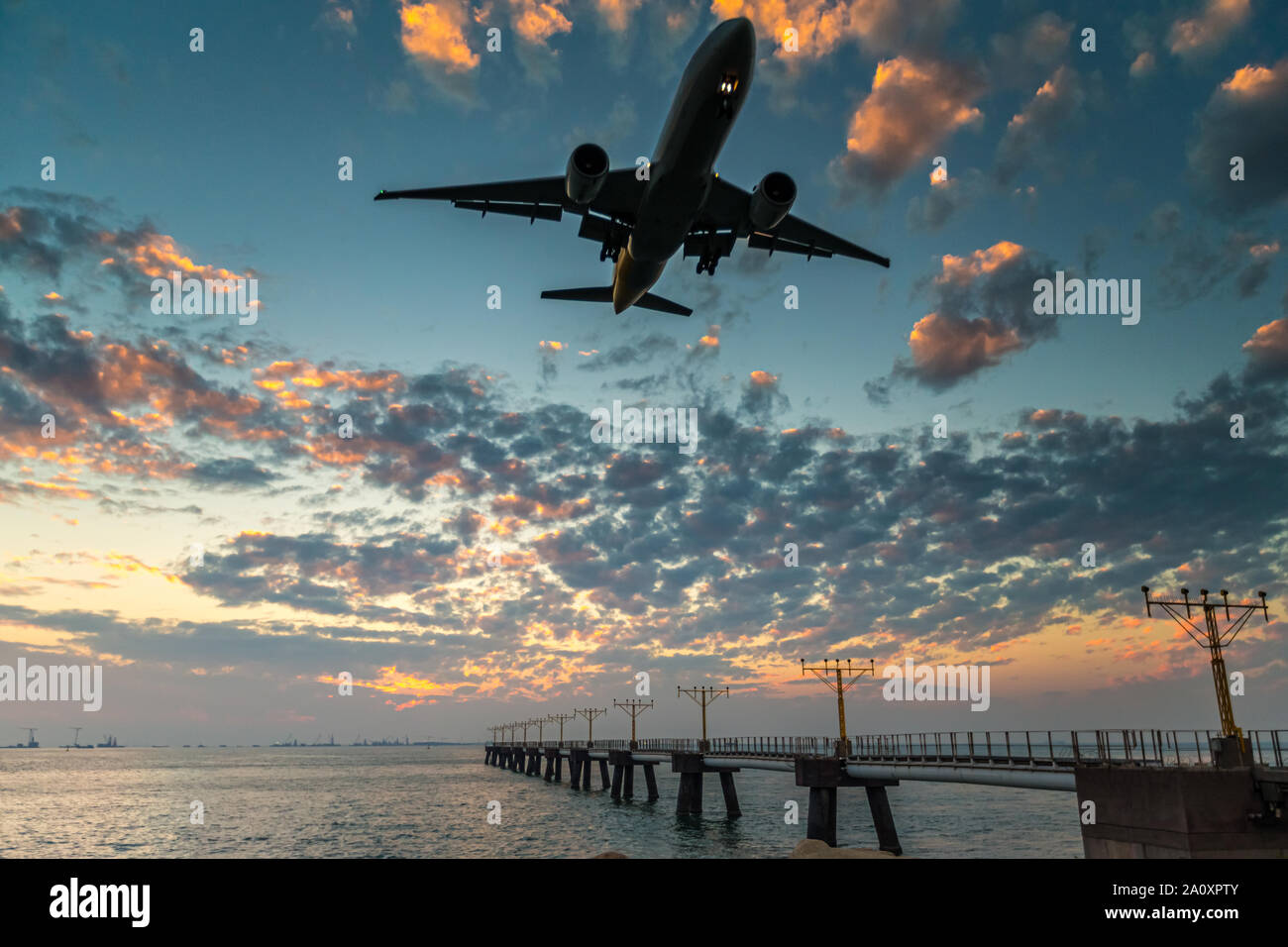 Airplane flying dramatic sunset sky hi-res stock photography and images ...