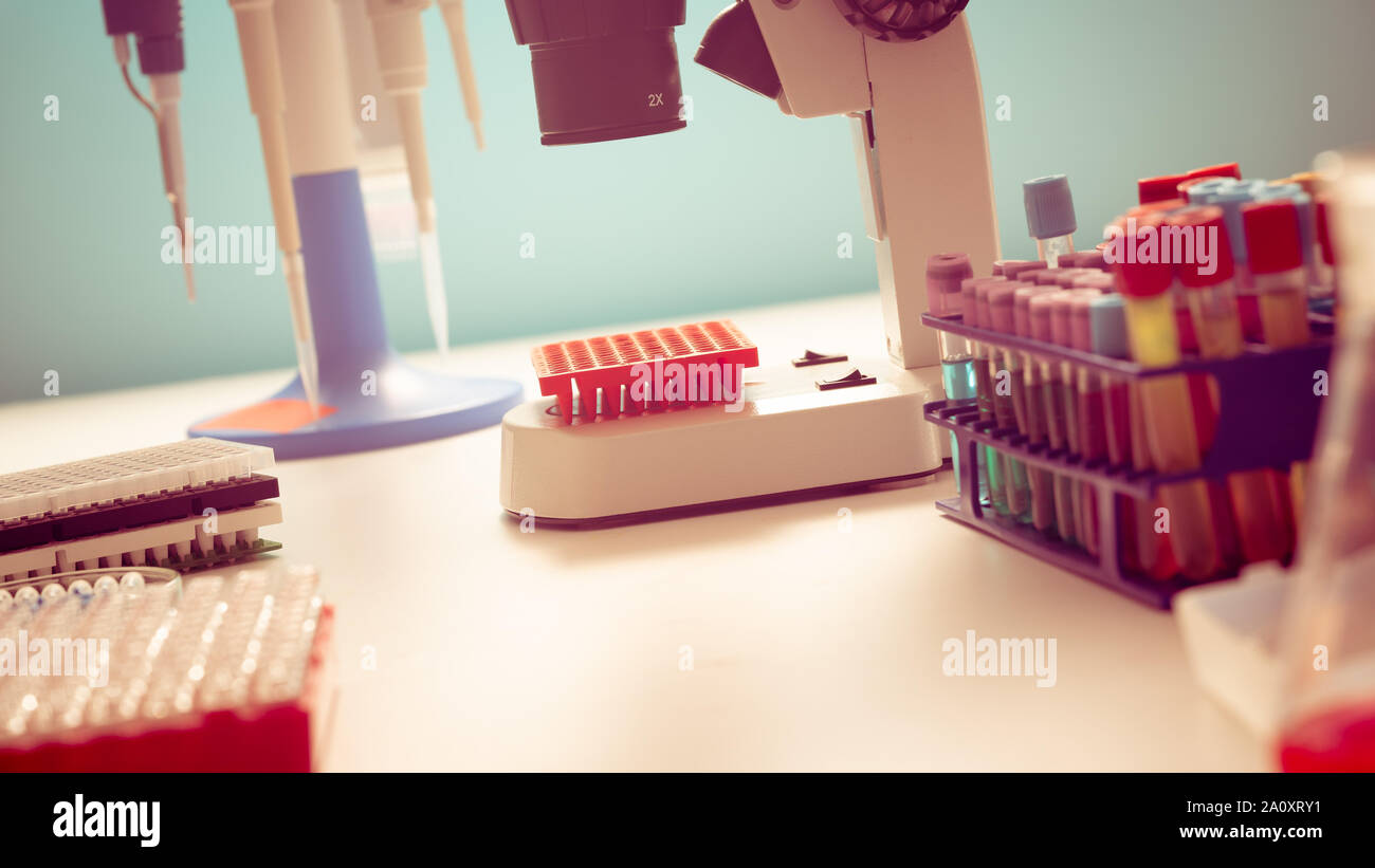 Scientific experiment in microbiological lab. Microscope and test tube ...