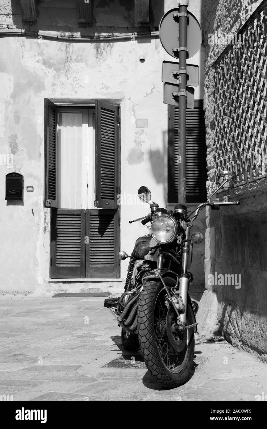 Vintage custom motorcycle standing in the street of old italian town ...